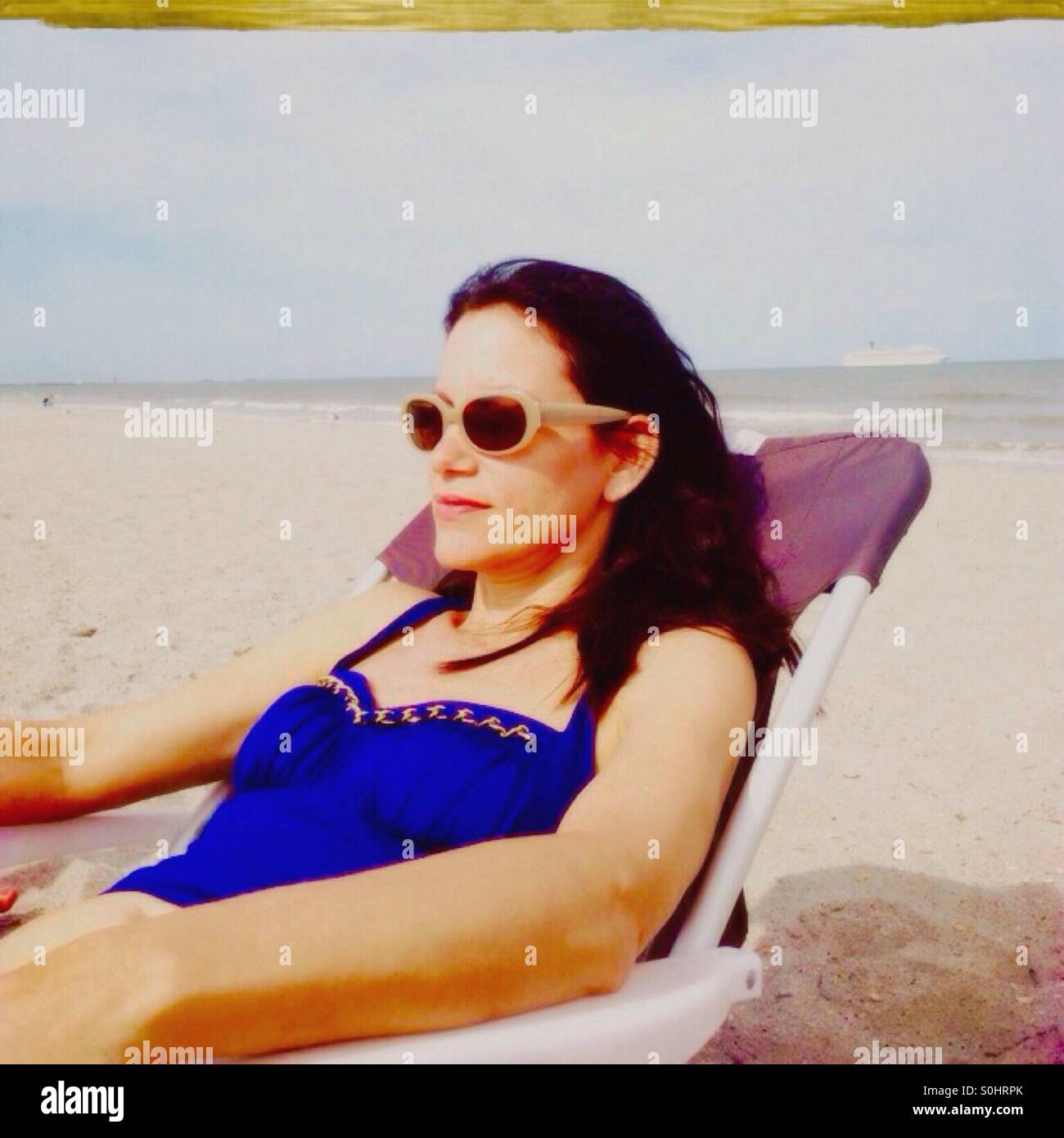 Woman lounging beach hi-res stock photography and images - Alamy
