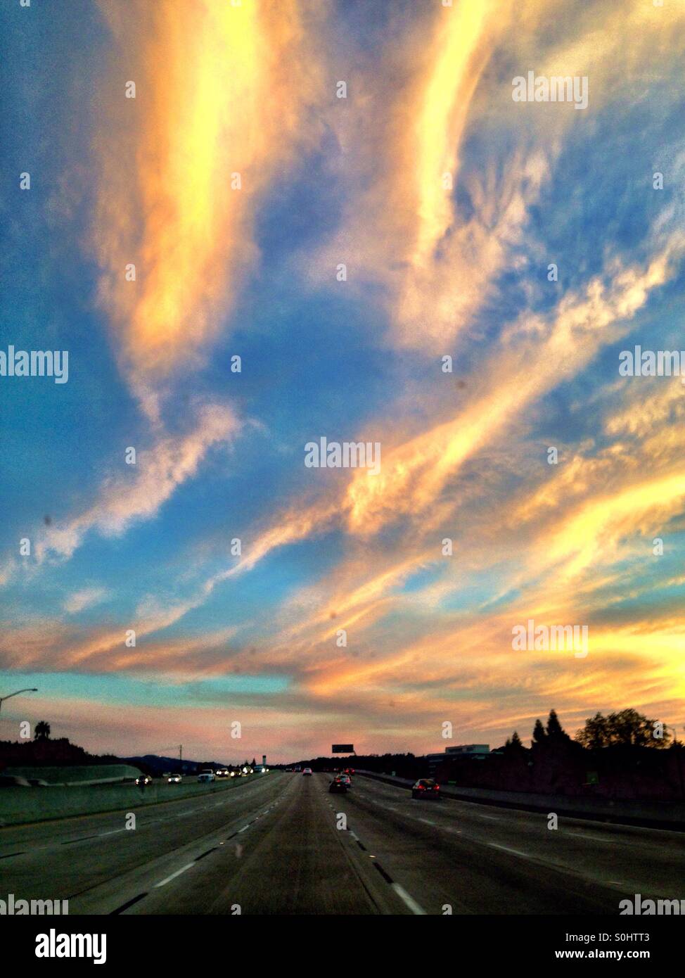 Vivid sunset over highway Stock Photo - Alamy