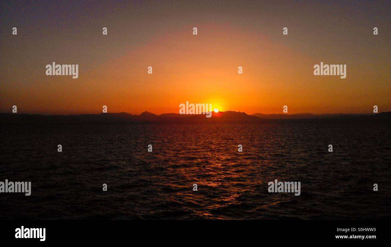 Sunset over Greek Island Stock Photo - Alamy