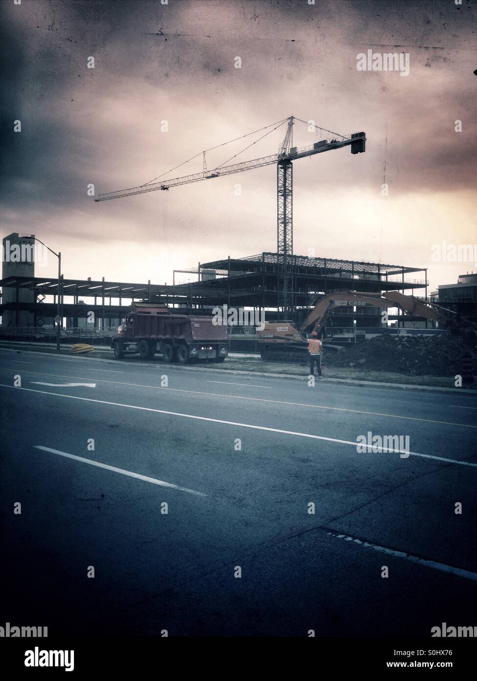 Man directing a truck in an off street construction site Stock Photo ...