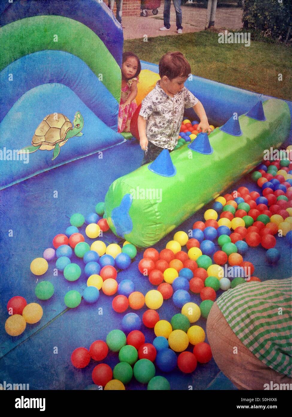 Young children playing on an inflatable Stock Photo - Alamy