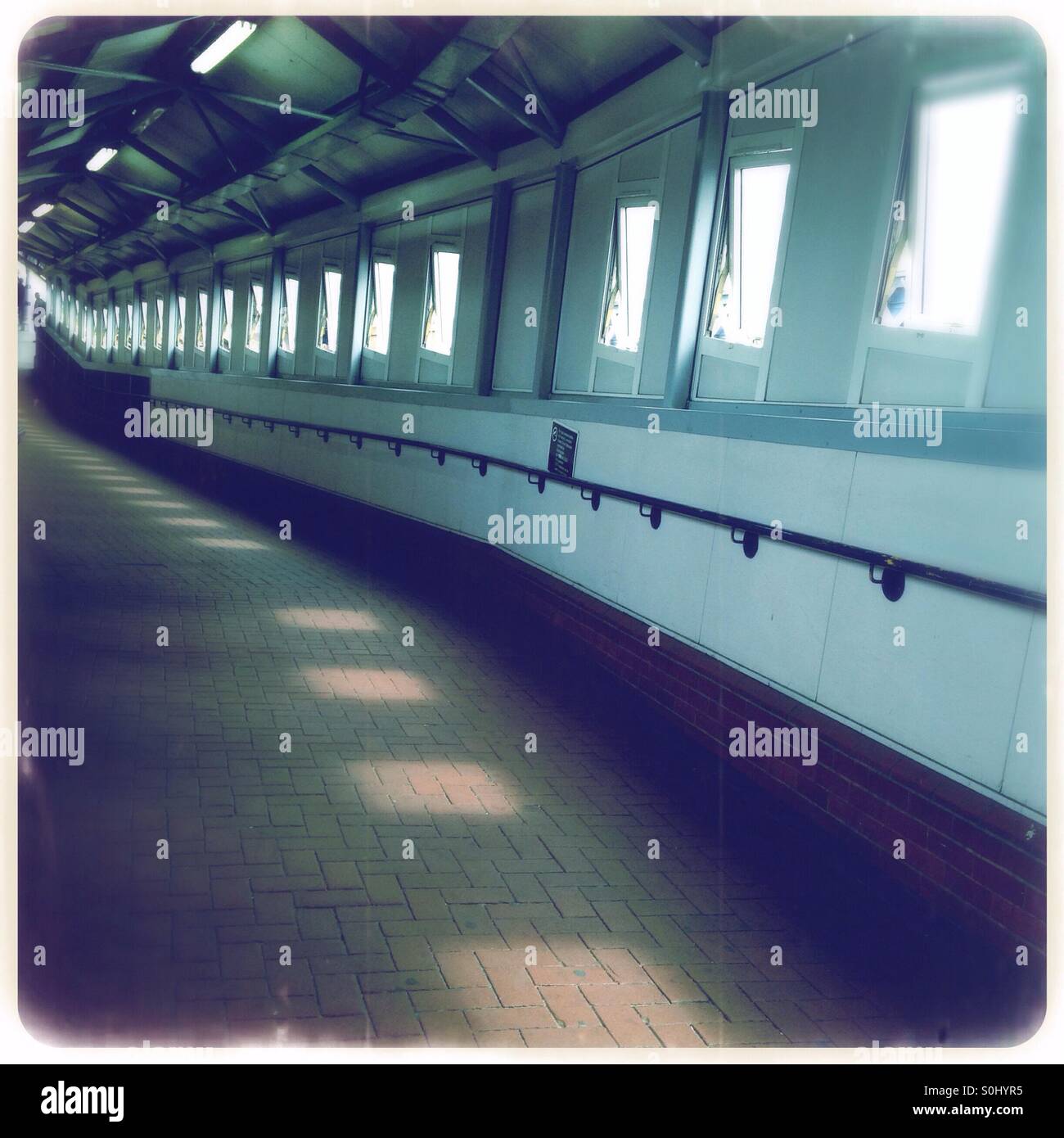 Walkway at train station Stock Photo - Alamy