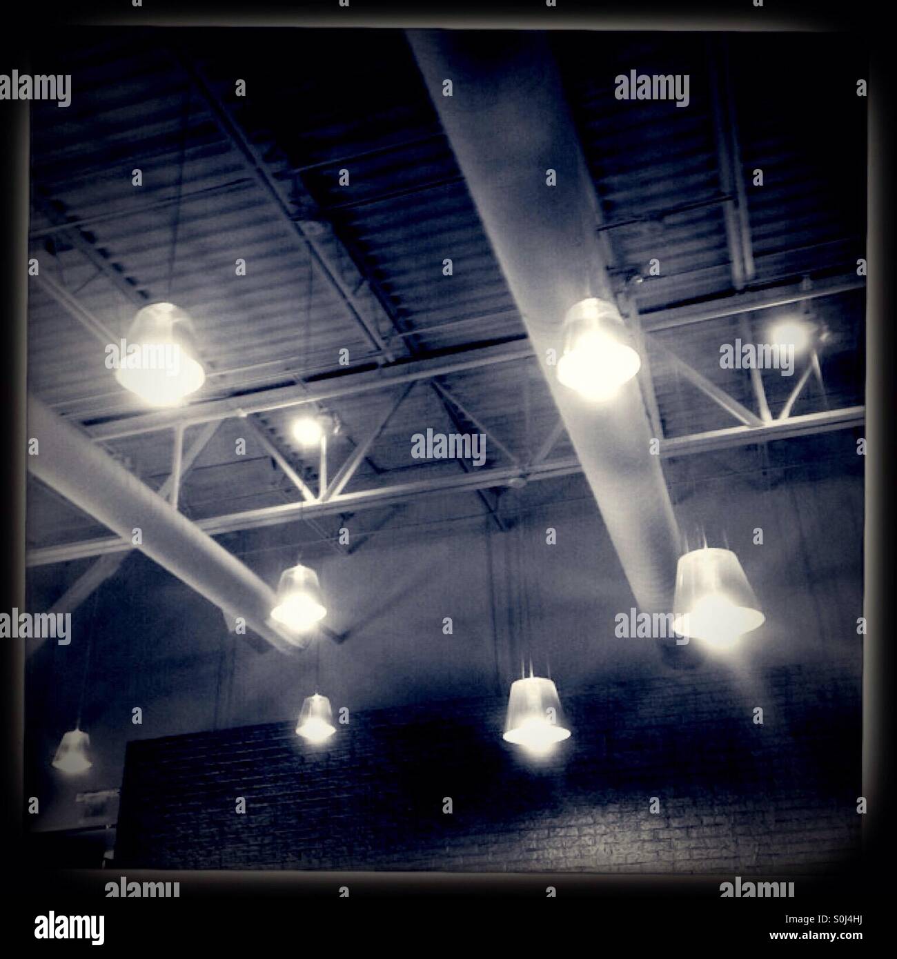 Warehouse ceiling with hanging lights Stock Photo - Alamy