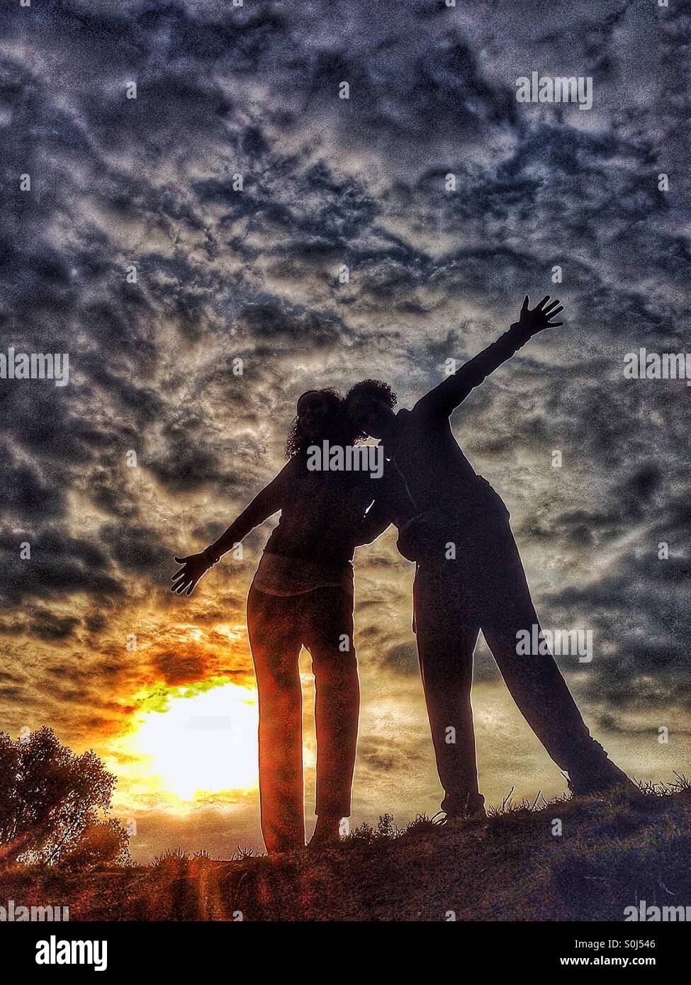 Sisters at sunset Stock Photo - Alamy