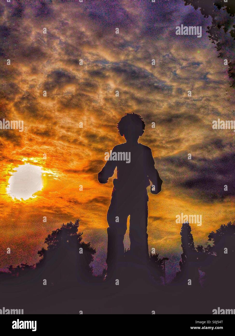 The boy at sunset Stock Photo - Alamy