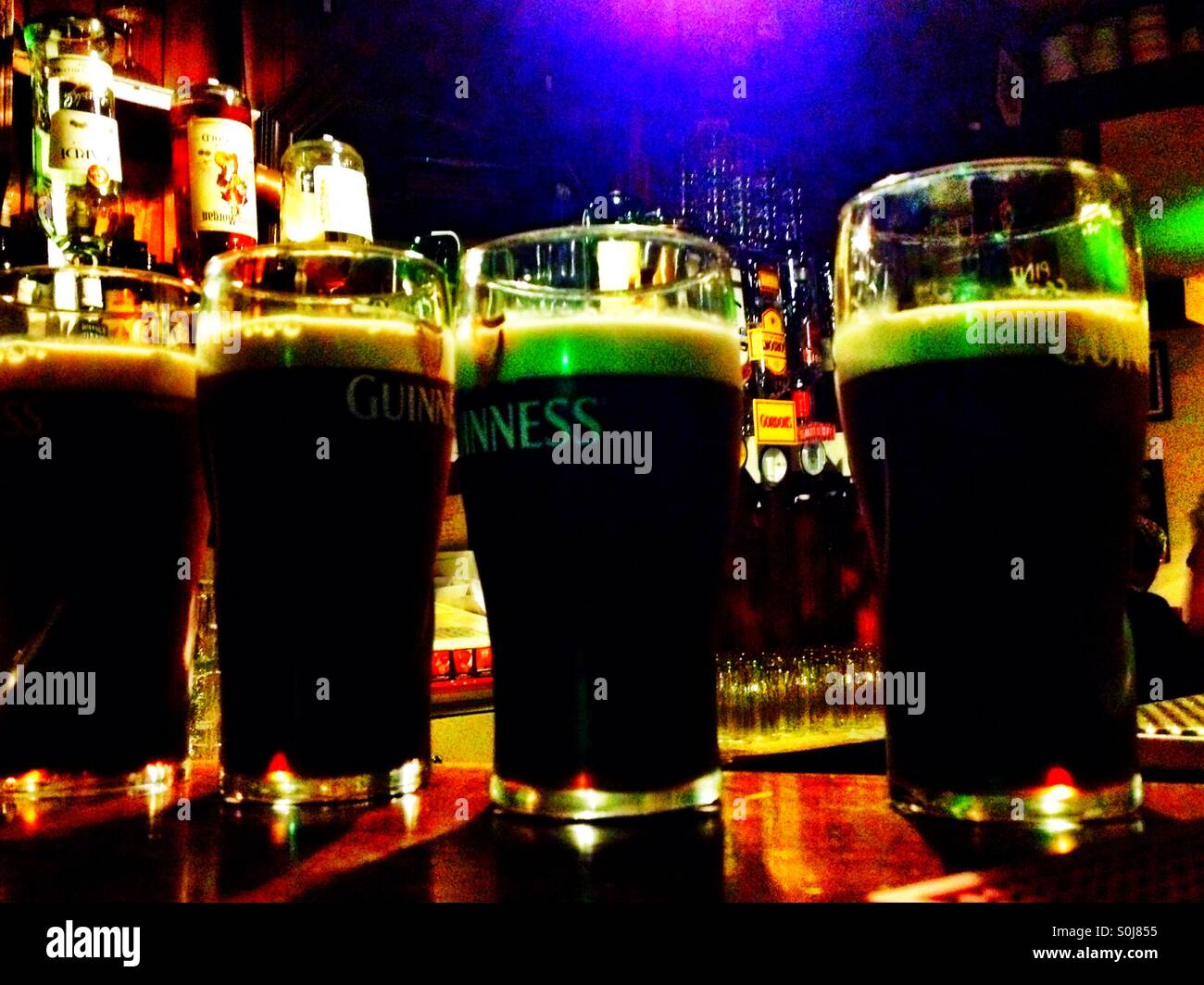Pints of Guinness on the bar Stock Photo - Alamy