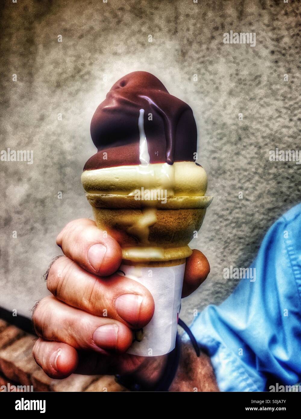 Man Holding A Vanilla Ice Cream Cone Dipped In Chocolate Stock Photo ...