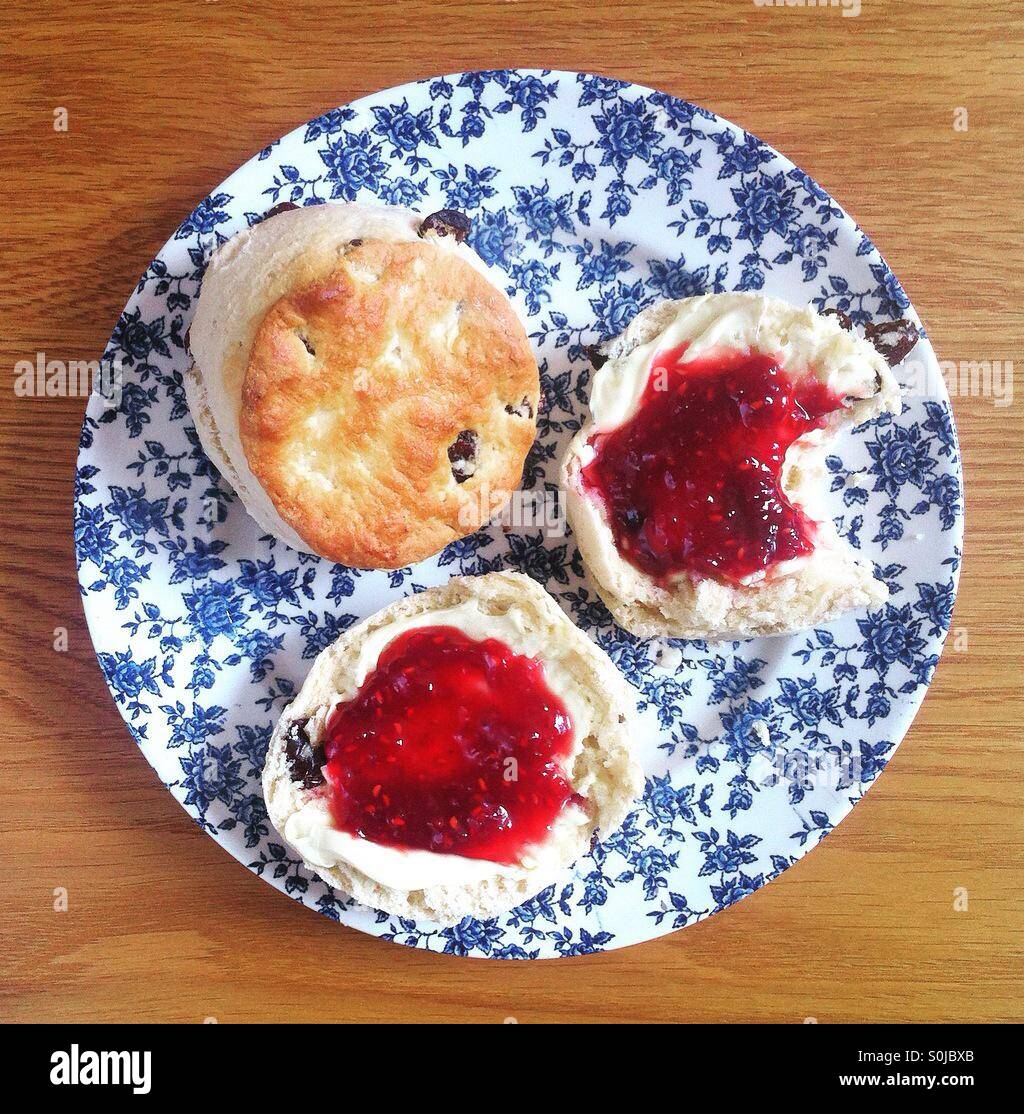 Homemade scones with raspberry jam on a blue and white floral china ...