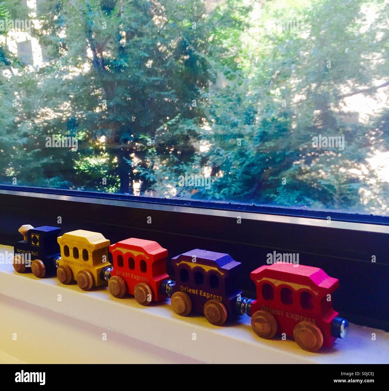Toy train on office window Stock Photo - Alamy