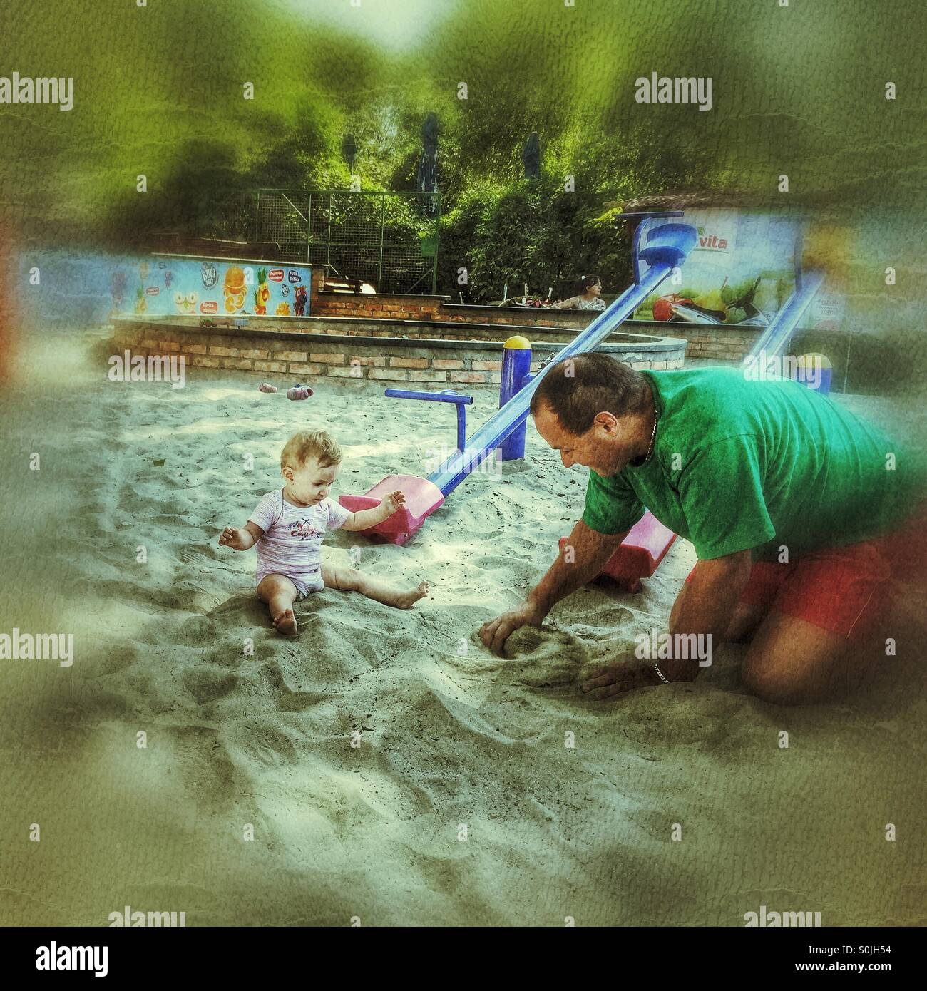 Father and toddler playing in playground Stock Photo - Alamy