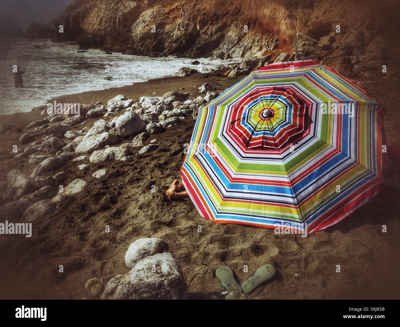 Beach people staying out of sun Stock Photo - Alamy