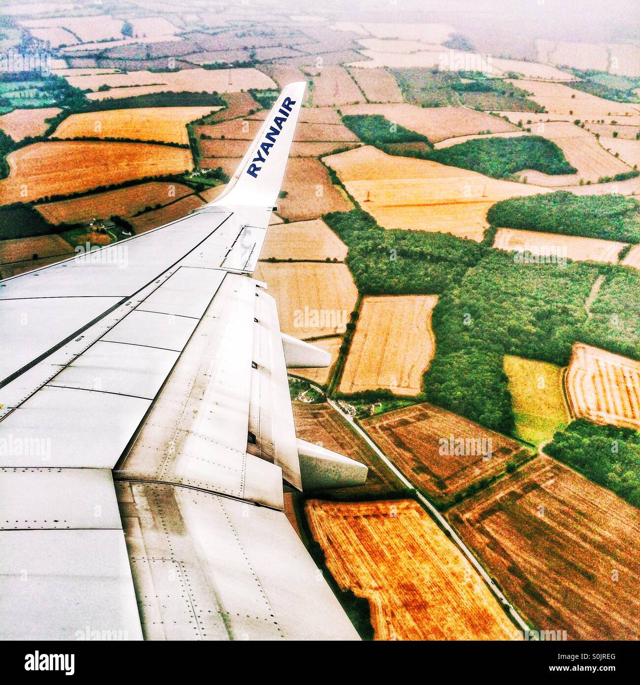 View outside window of Ryanair plane flying above fields Stock Photo ...