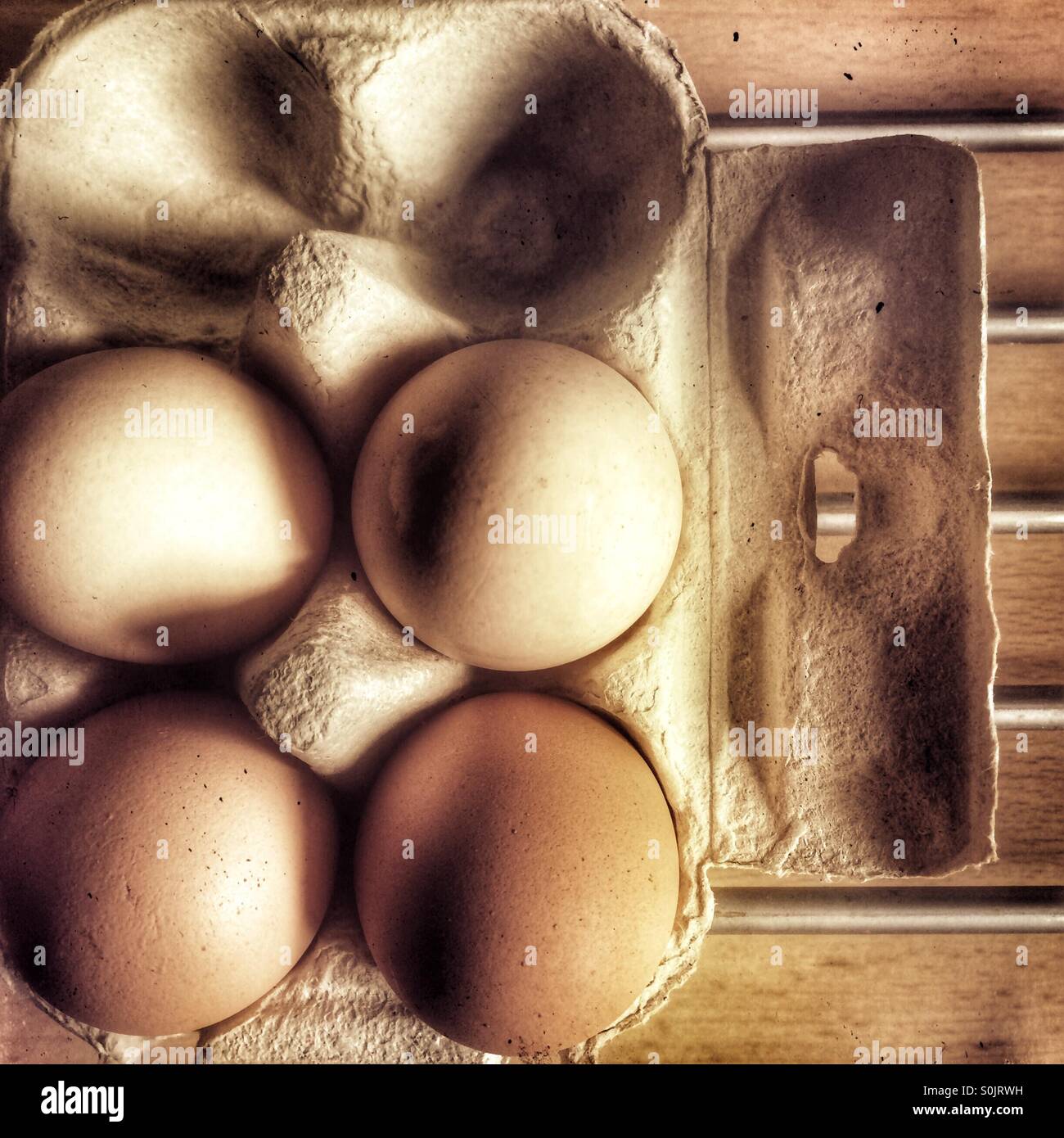 Four eggs in box Stock Photo - Alamy