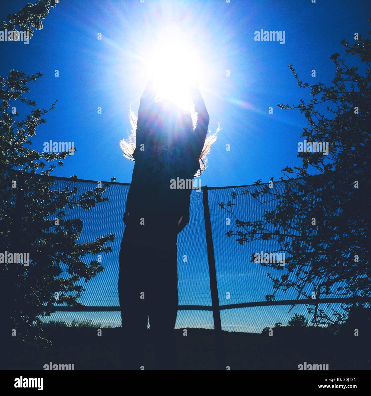 Girl silhouette jumping and catching the sun Stock Photo - Alamy
