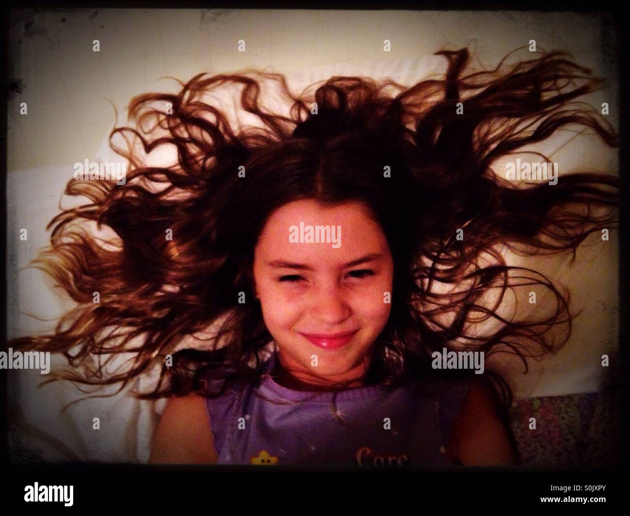 Girl with wild hair on pillow Stock Photo - Alamy