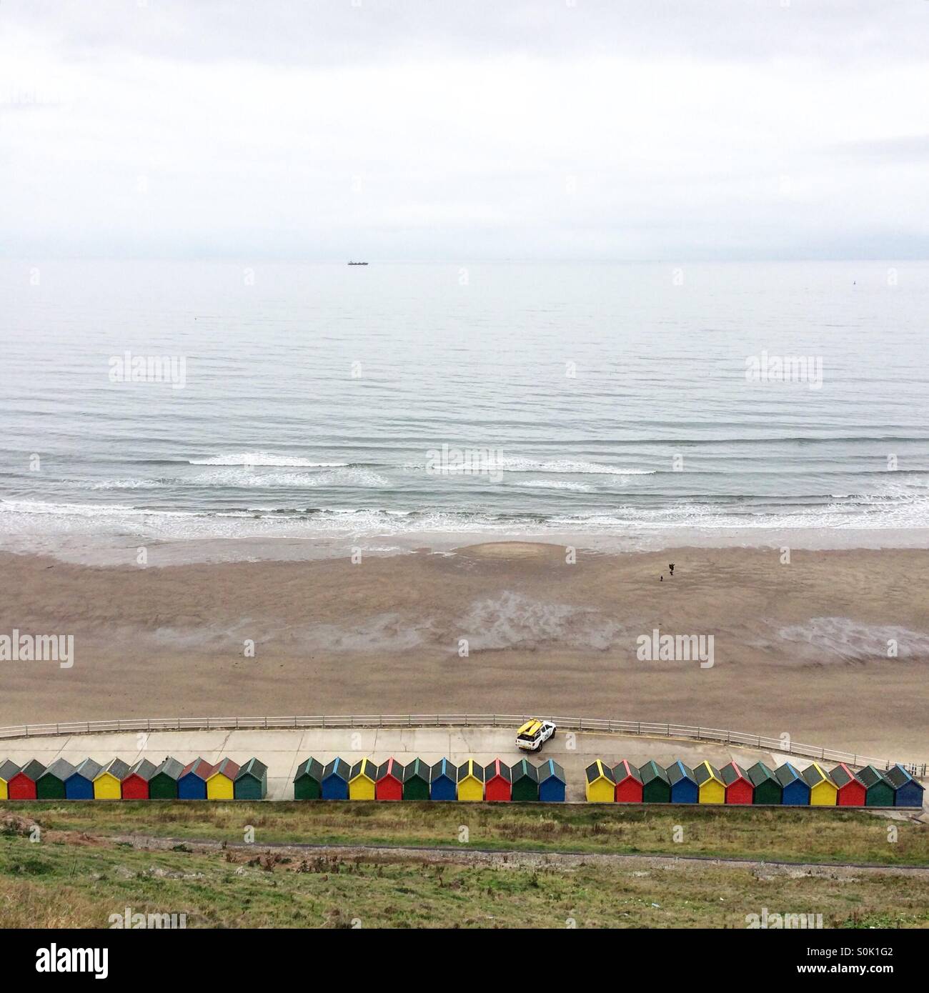 Whitby coastline seafront with beach huts Stock Photo - Alamy