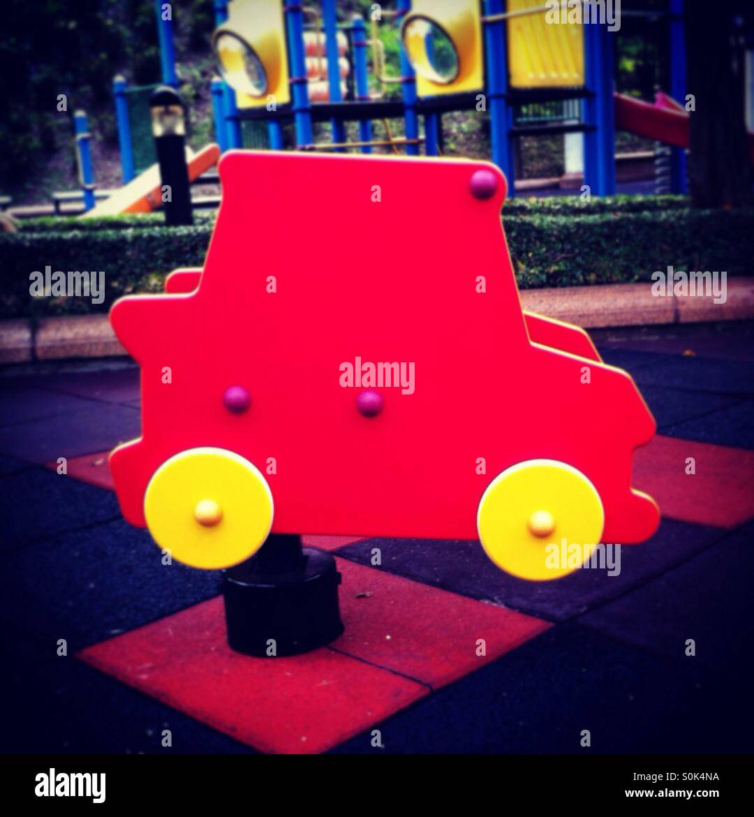 Red car toy on playground Stock Photo - Alamy