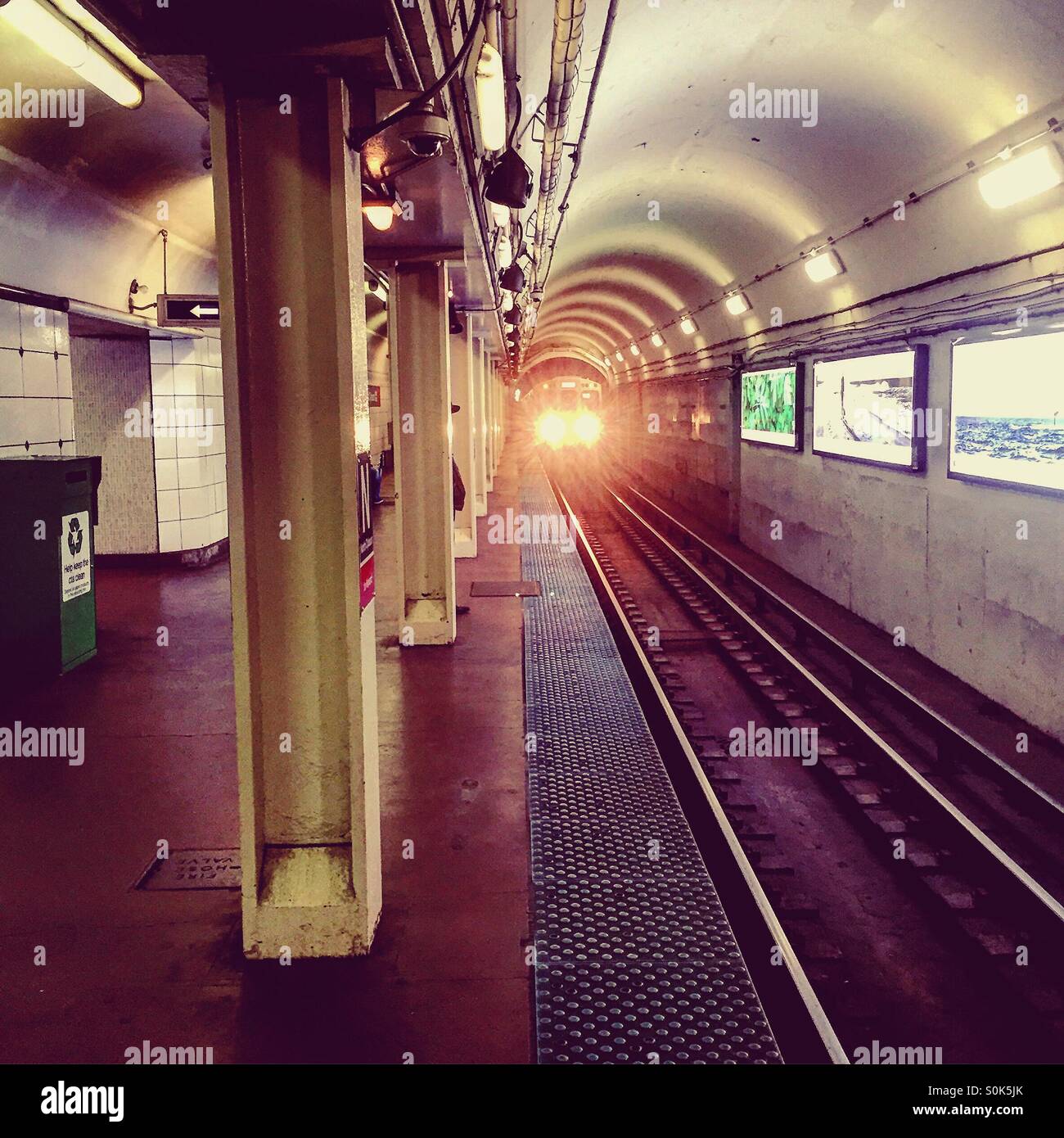 Headlights of approaching train in subway station Stock Photo - Alamy