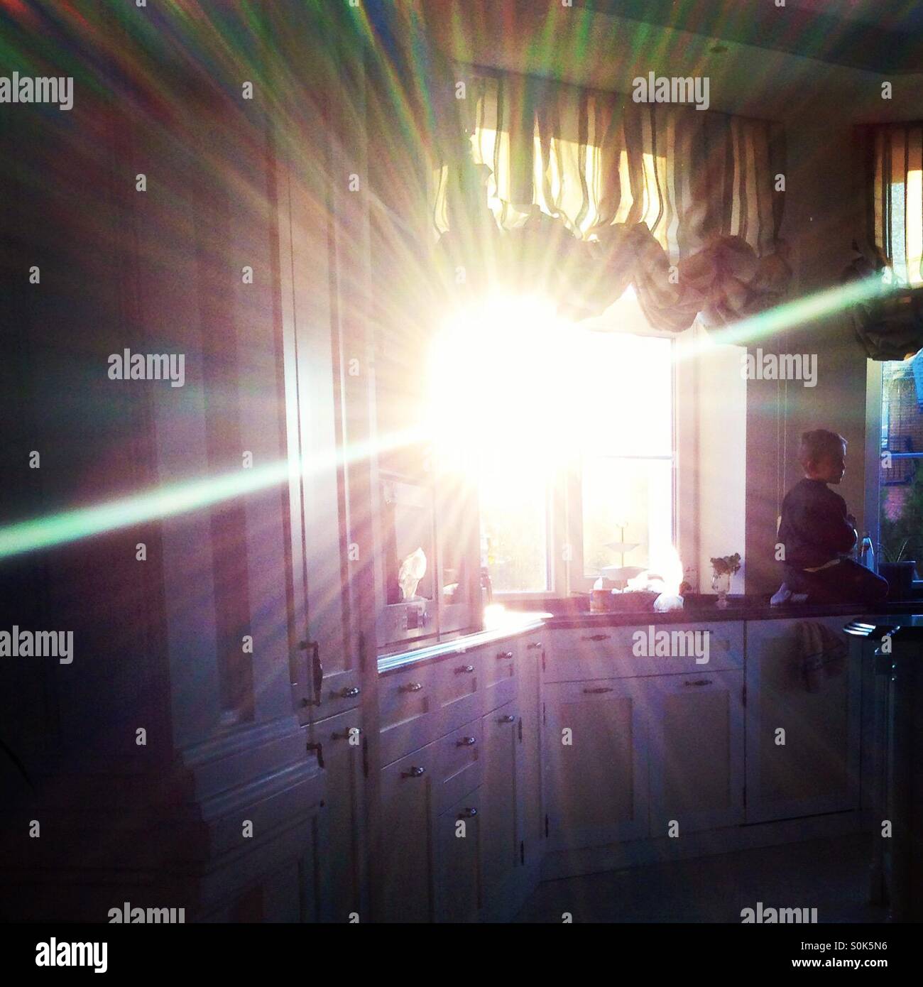 sun lights in kitchen's window Stock Photo - Alamy