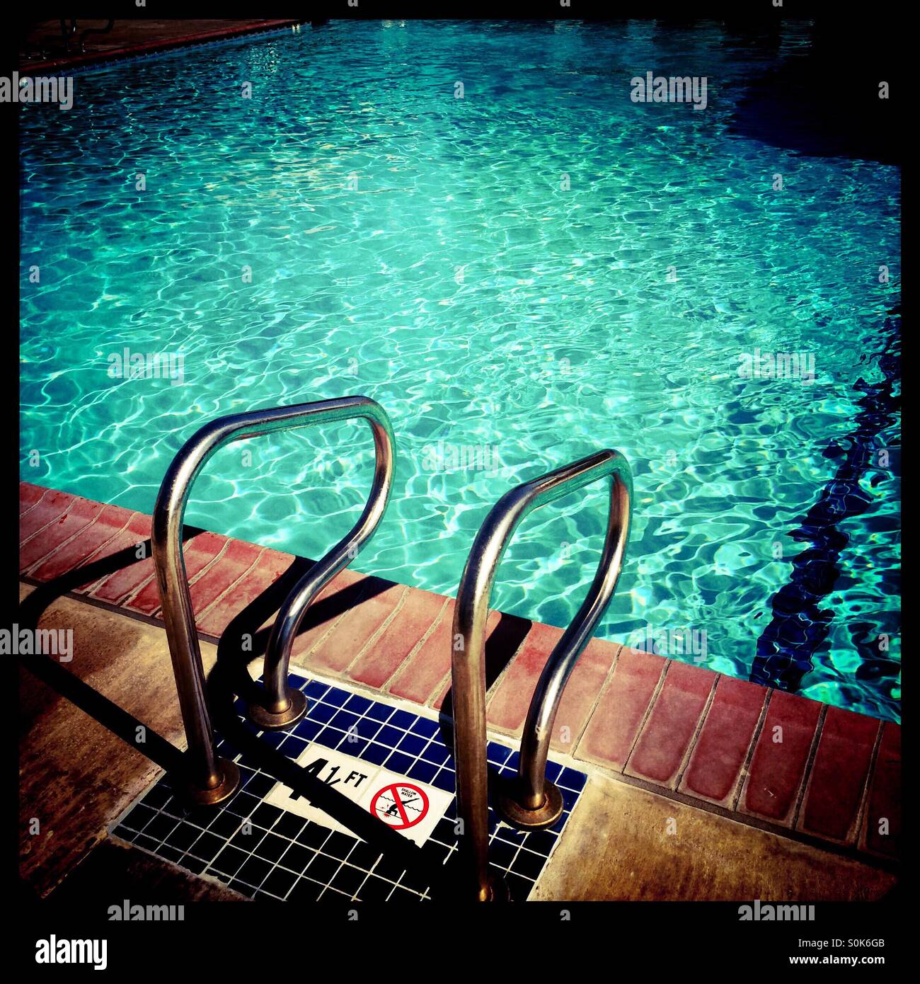 A ladder at an empty swimming pool Stock Photo - Alamy
