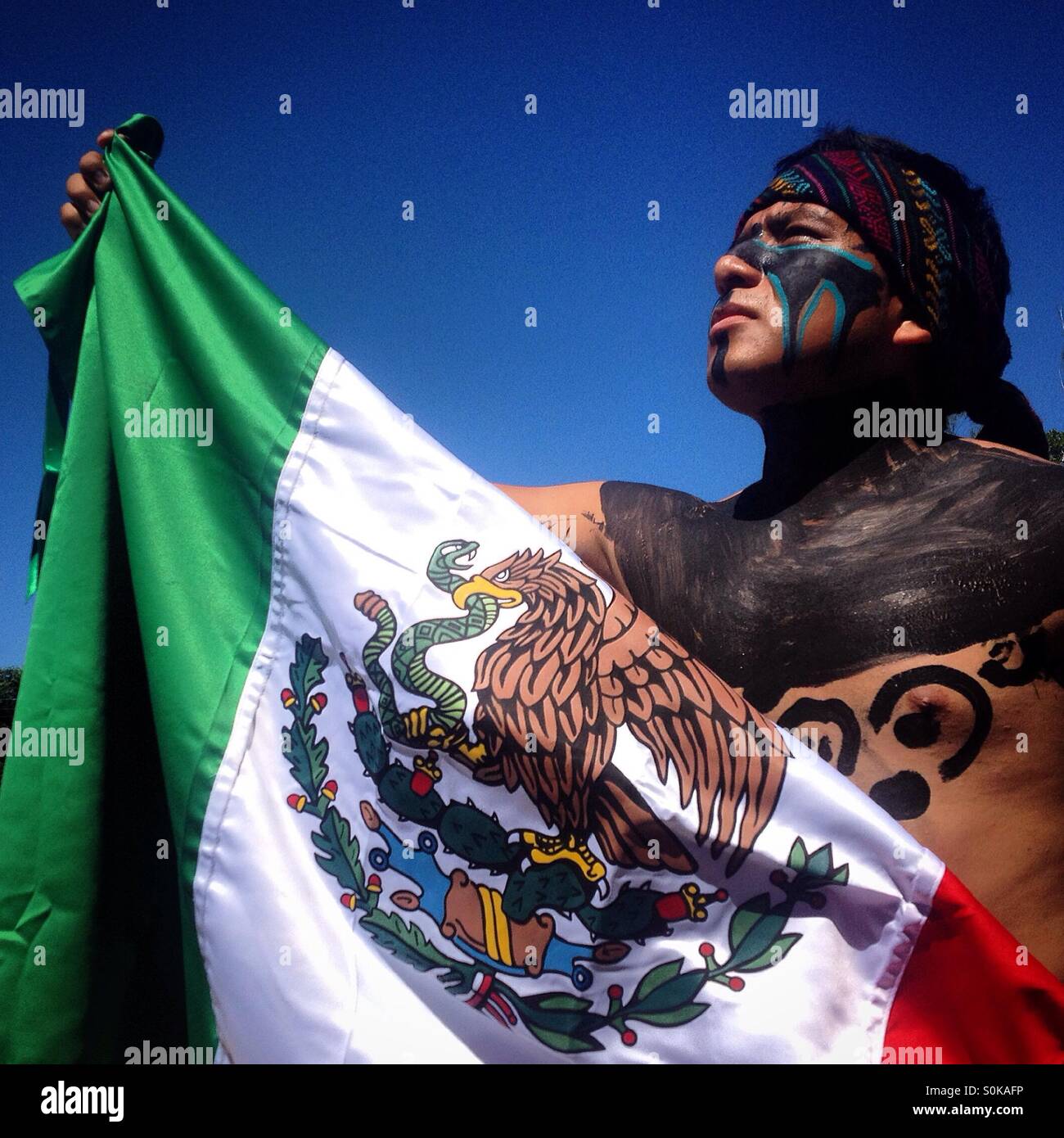 A Mayan ball player from Mexico hold the Mexican Flag at the opening ...