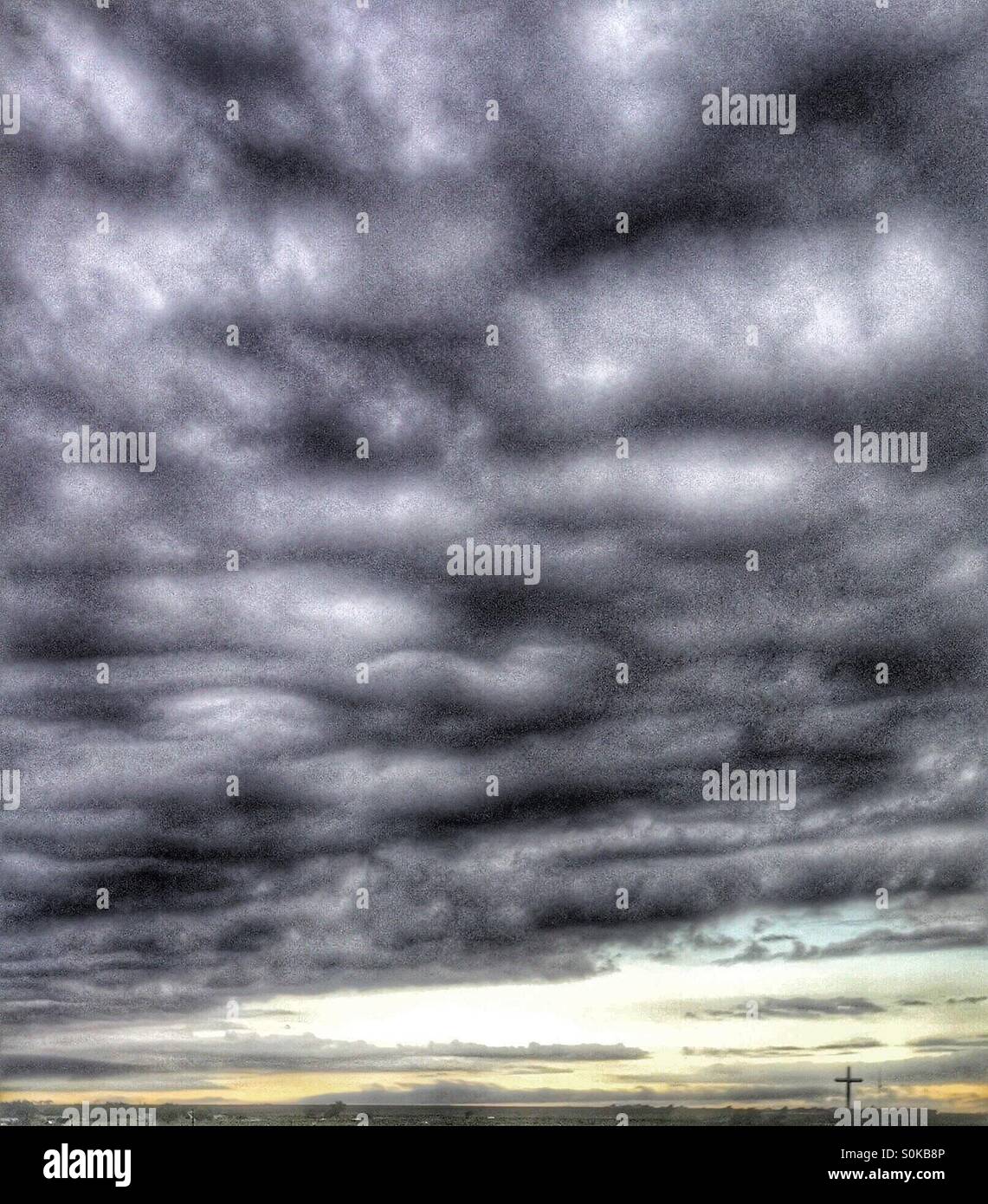 Storm clouds with cross in the distance Stock Photo - Alamy