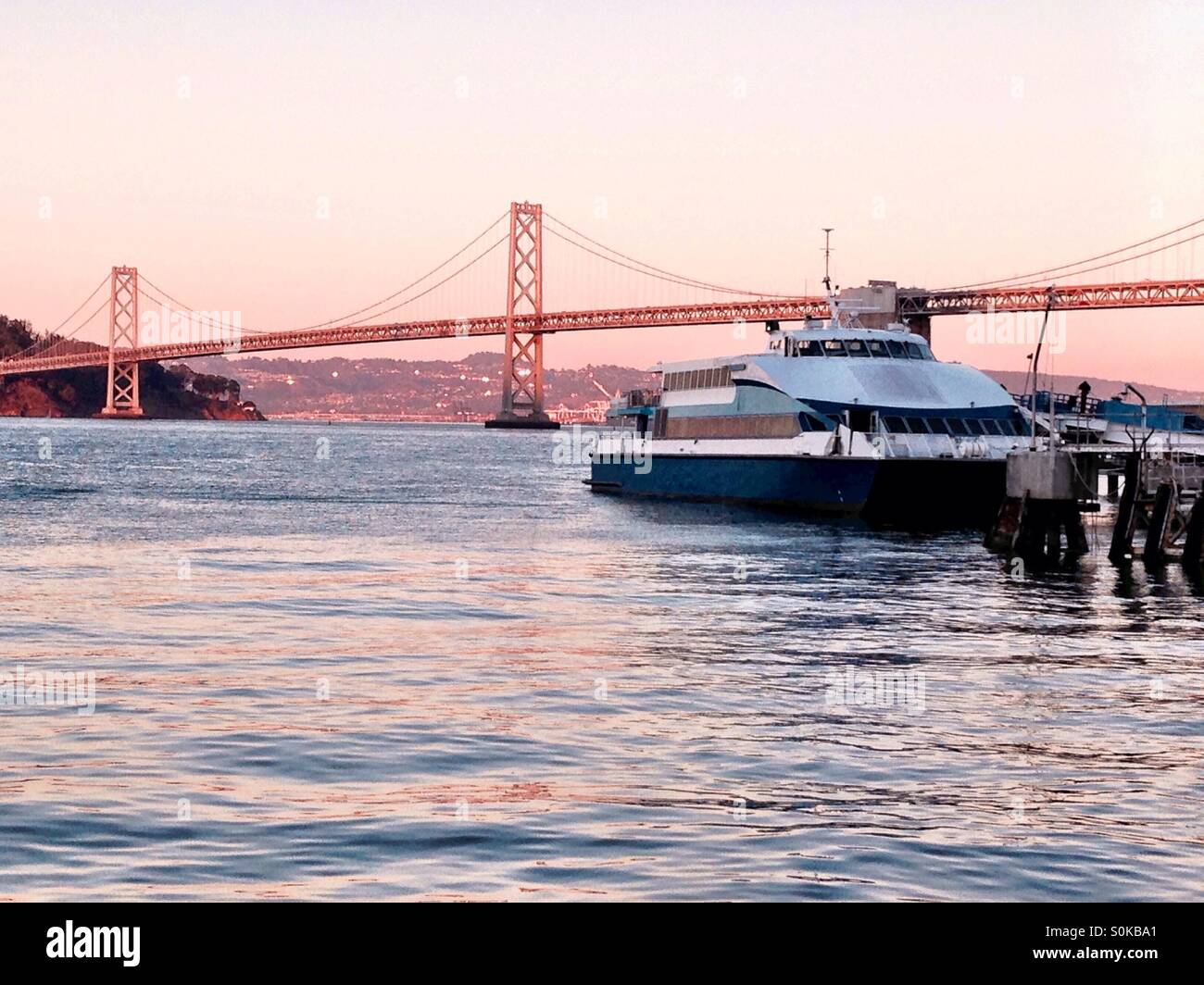 Public ferry boat and Bay Bridge Stock Photo - Alamy