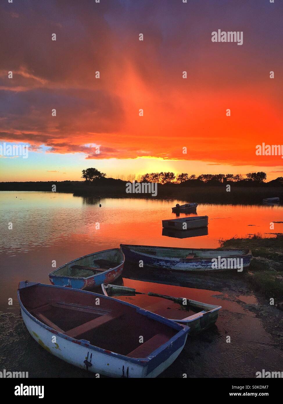 Rowing boats at sunset hi-res stock photography and images - Alamy