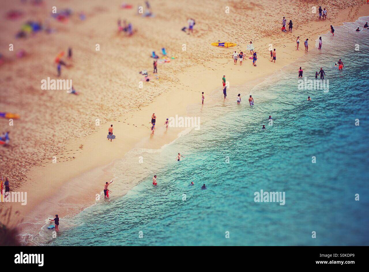 A busy beach full of holidaymakers, sunbathers and swimmers. A view ...
