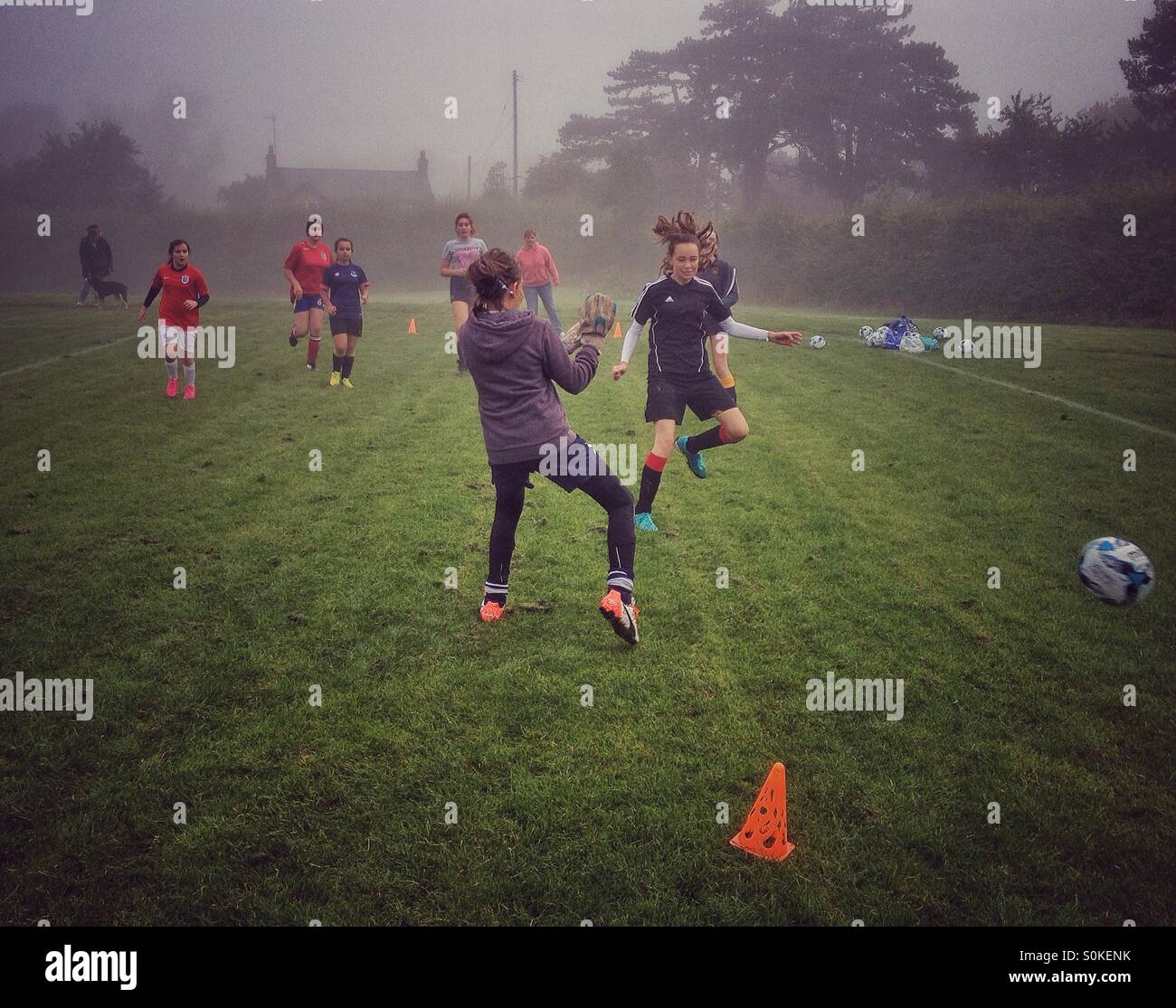 Girls playing football hi-res stock photography and images - Alamy