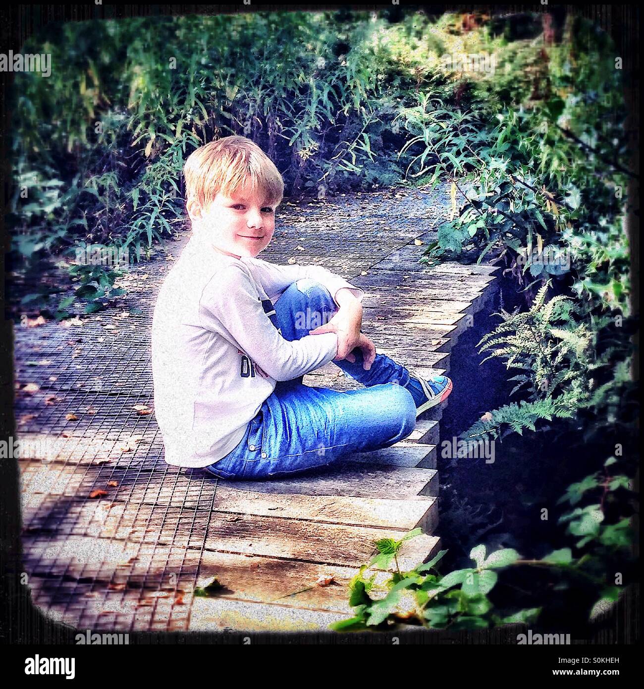 Boy taking a rest whilst out on a nature ramble Stock Photo - Alamy