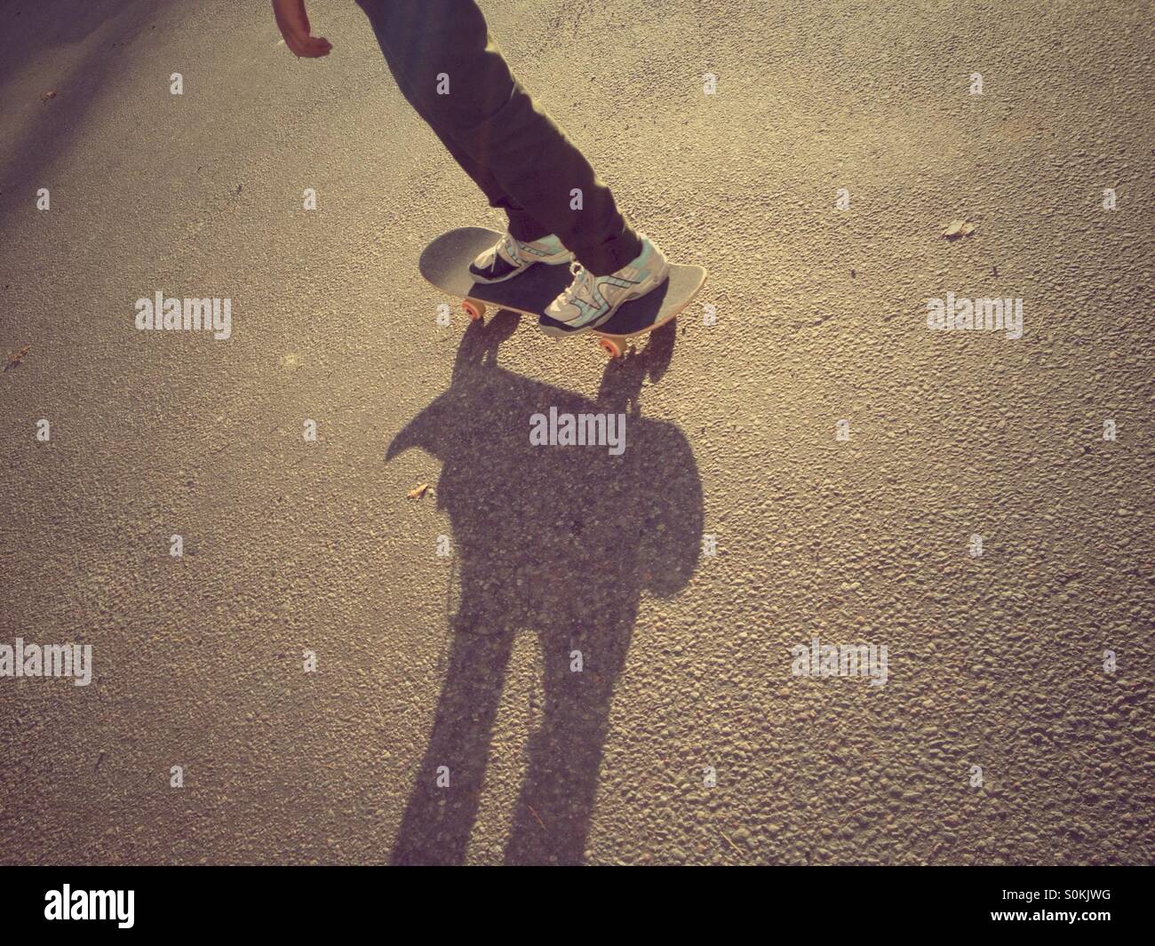 Skateboarder in twilight with shadow Stock Photo - Alamy