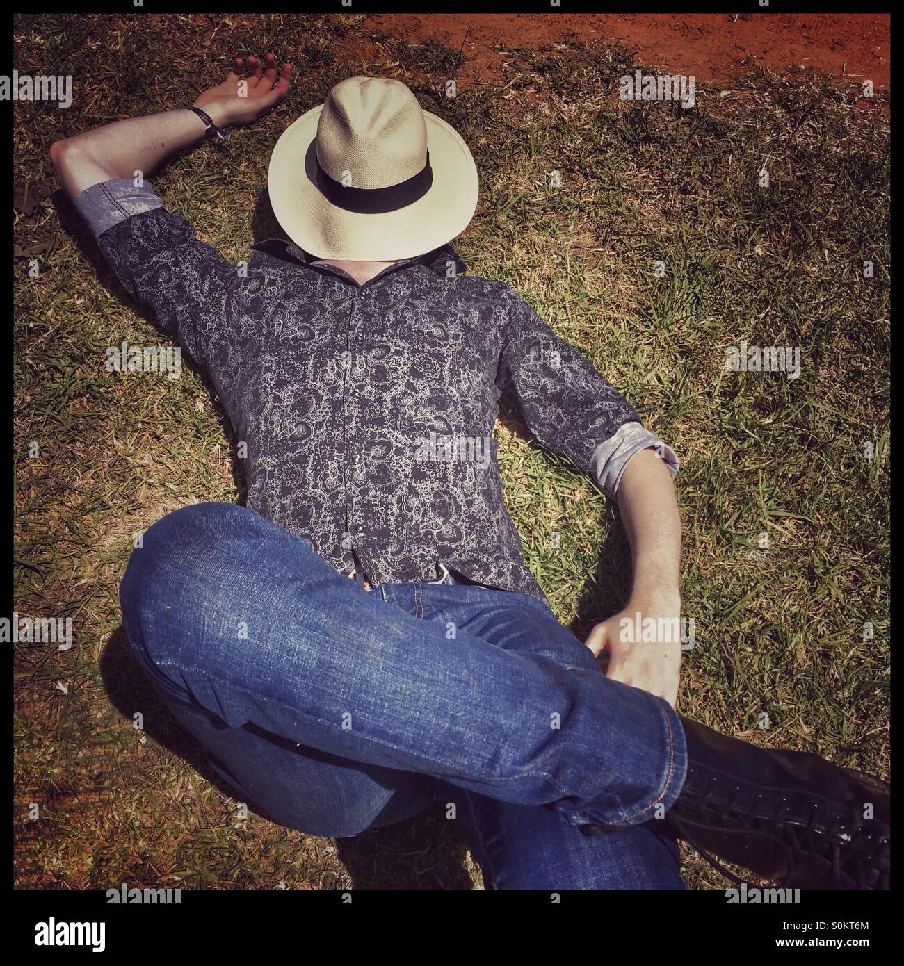 Hat covering face hi-res stock photography and images - Alamy