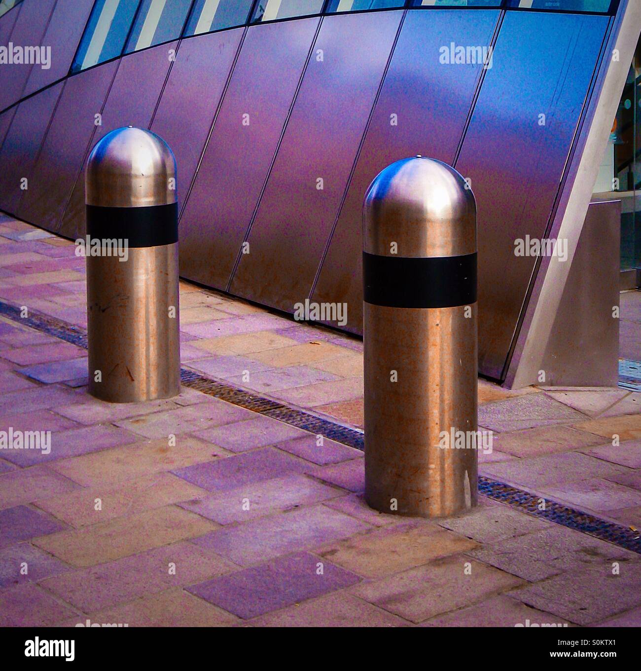 Security pillars and modern steel building Stock Photo - Alamy