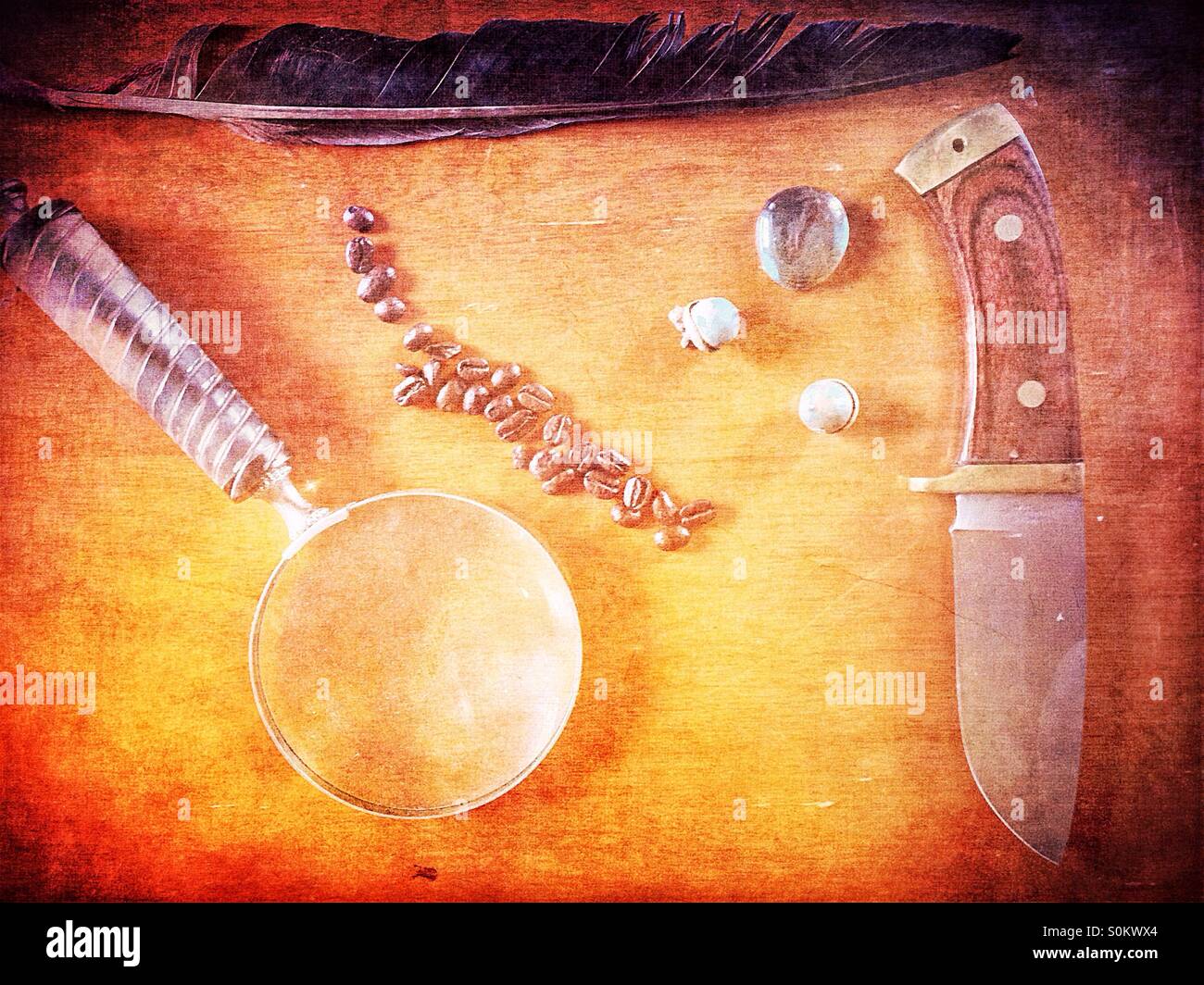 Found items still life with magnifying glass, knife, coffee beans ...