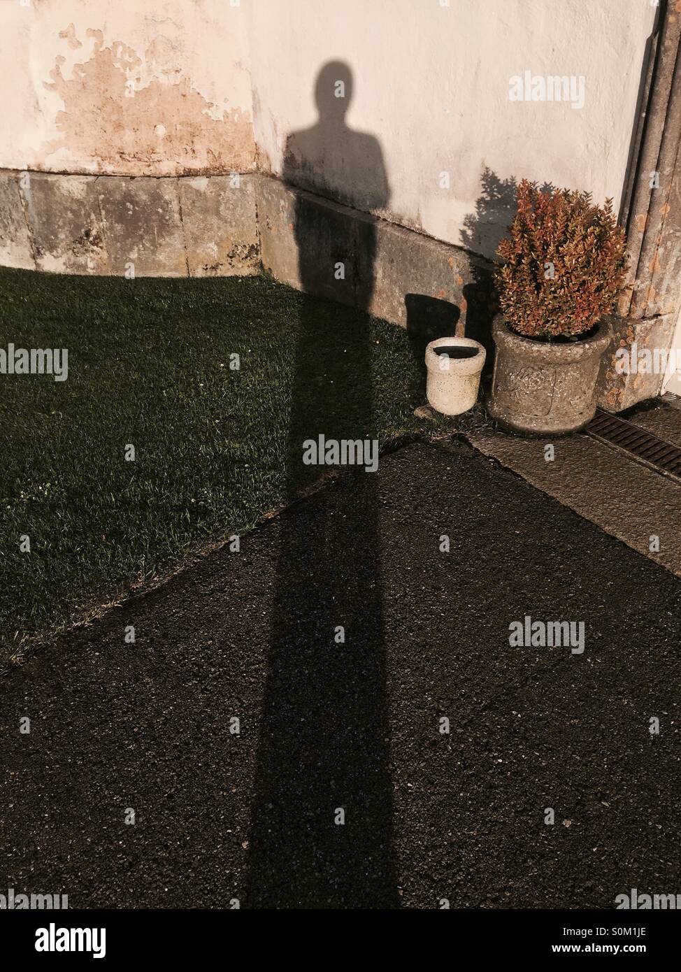 Elongated shadow against old stone wall Stock Photo - Alamy