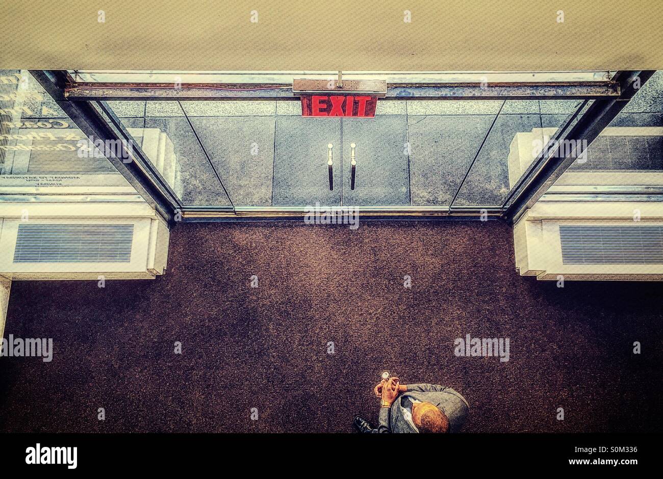 Large glass doors and exit sign shot from above Stock Photo - Alamy