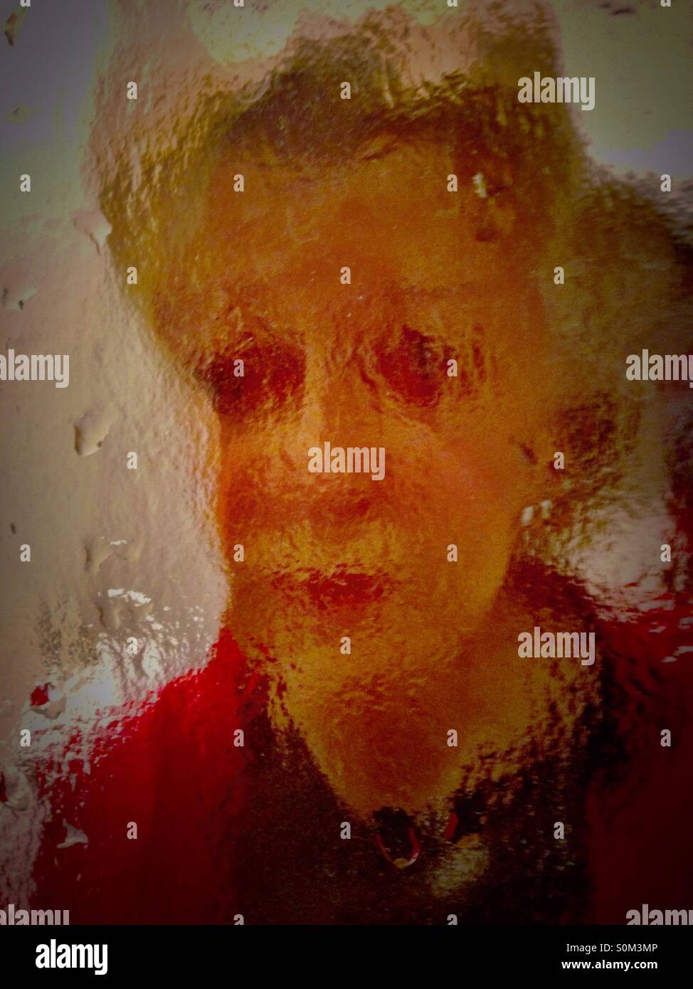 Woman's face through a wet window Stock Photo - Alamy