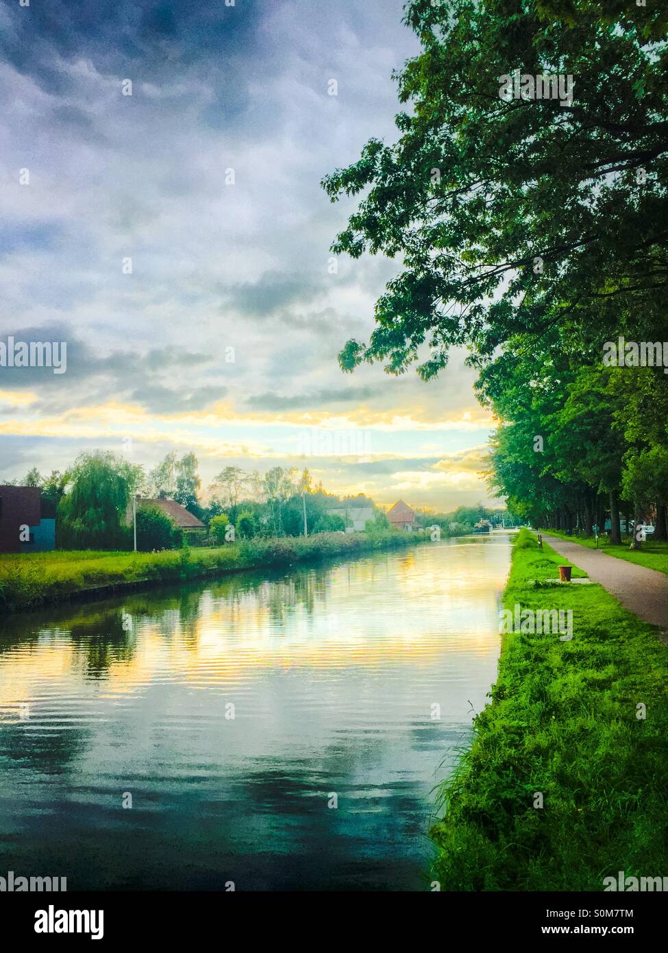 Clouded Sunset over a Canal Stock Photo - Alamy