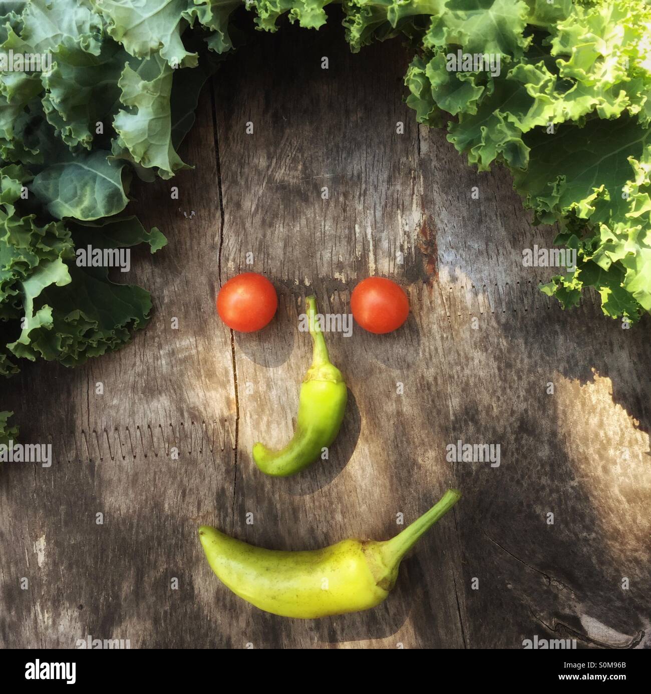 Vegetable face on Wood Background Stock Photo - Alamy