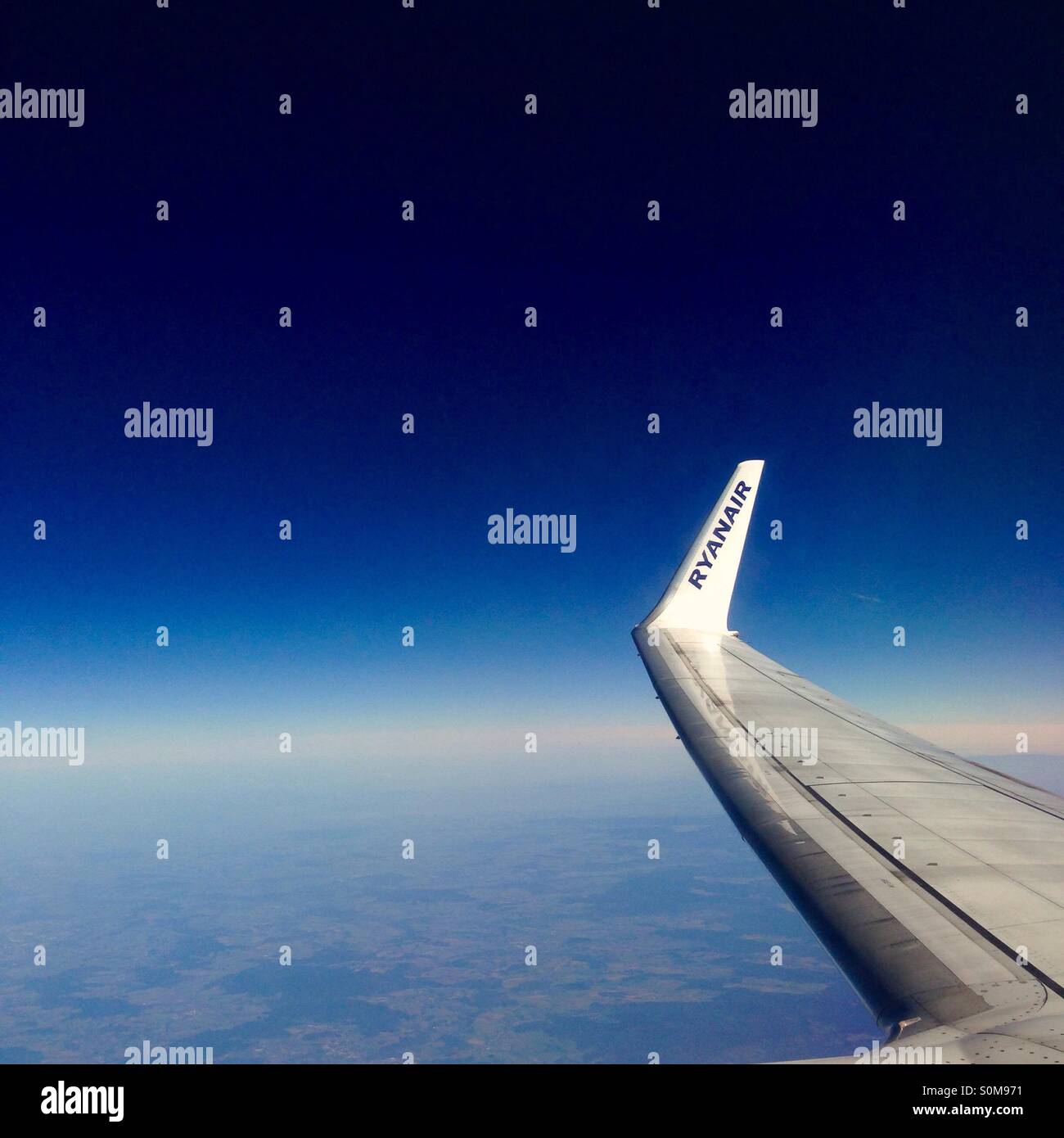 RyanAir wing with blue sky in background Stock Photo - Alamy