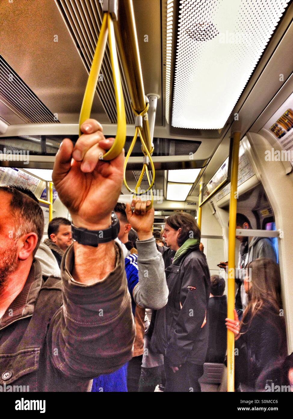 Hanging on inside a circle line train Stock Photo - Alamy