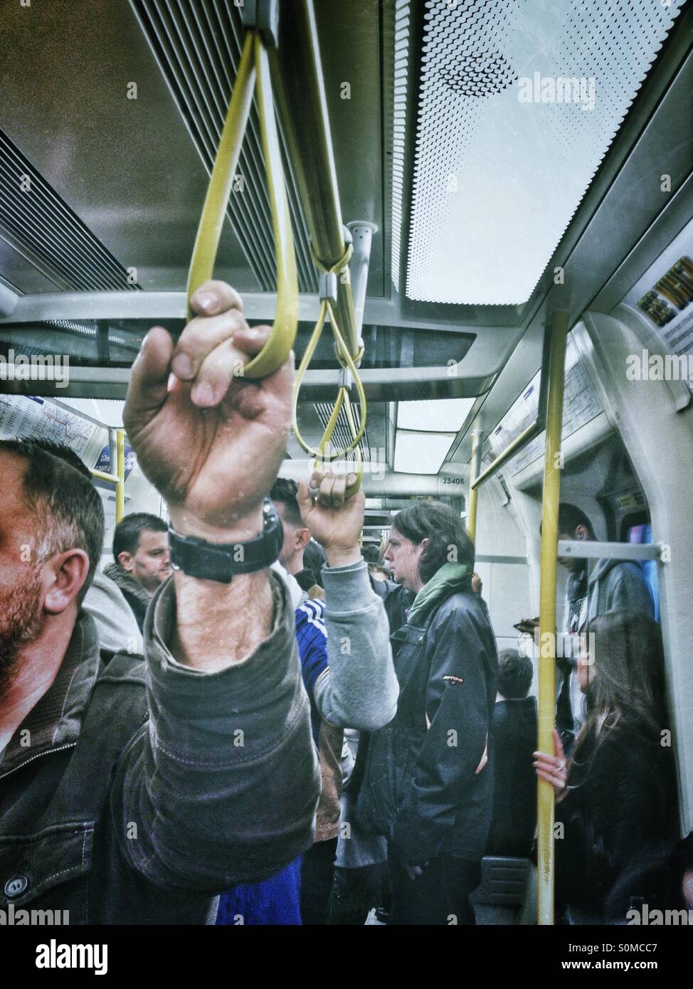 Hanging on ins circle line train Stock Photo - Alamy