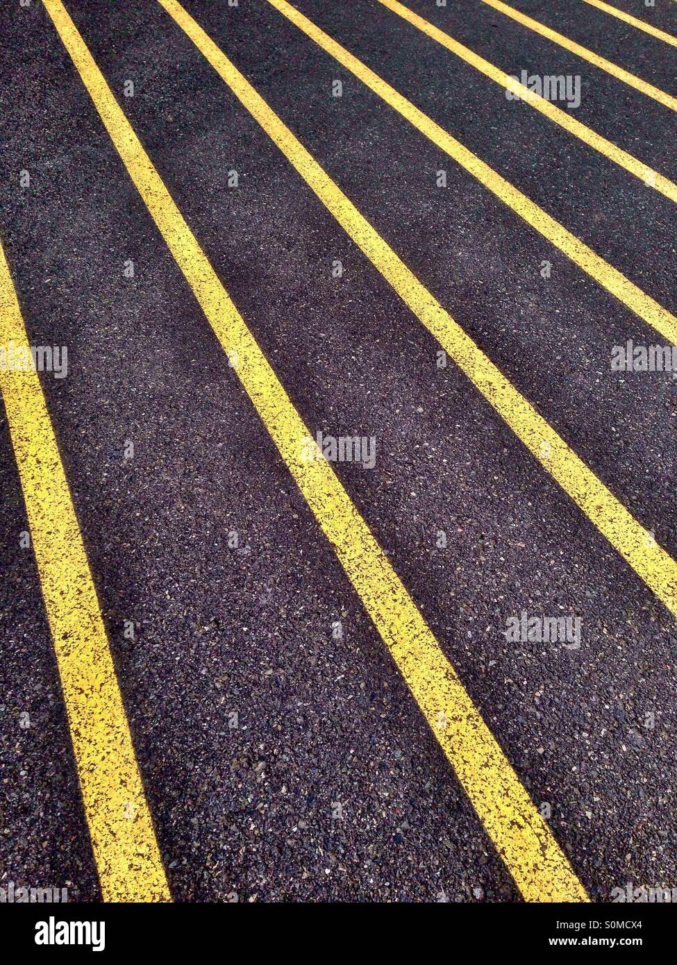 Yellow lines on athletic running track Stock Photo - Alamy