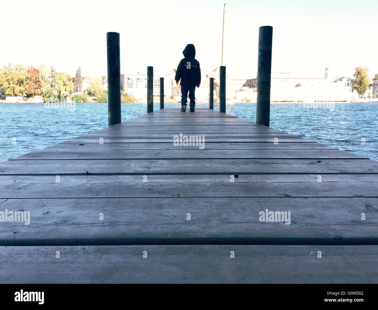 Boy on jetty hi-res stock photography and images - Alamy