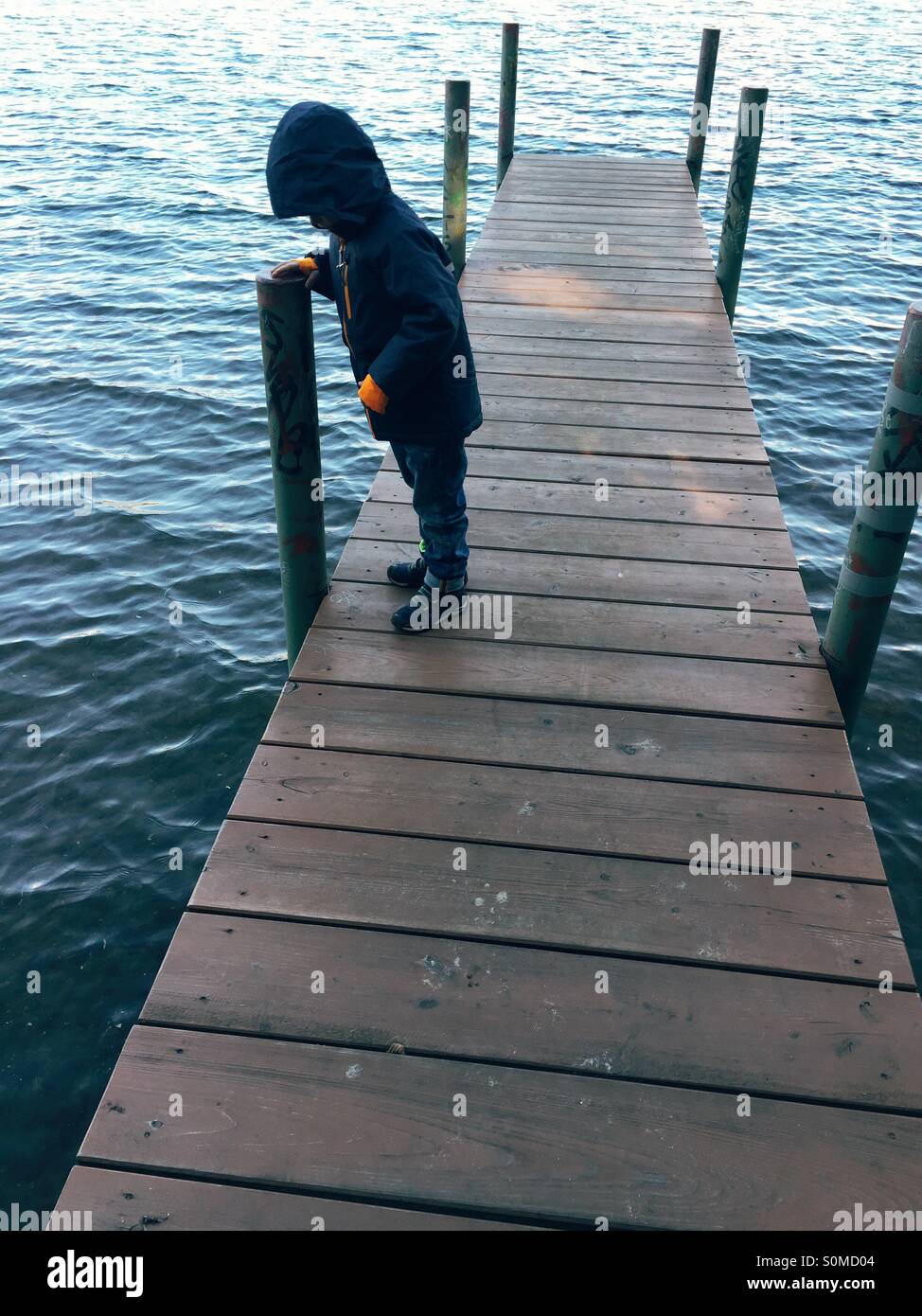 Boy on a jetty hi-res stock photography and images - Alamy