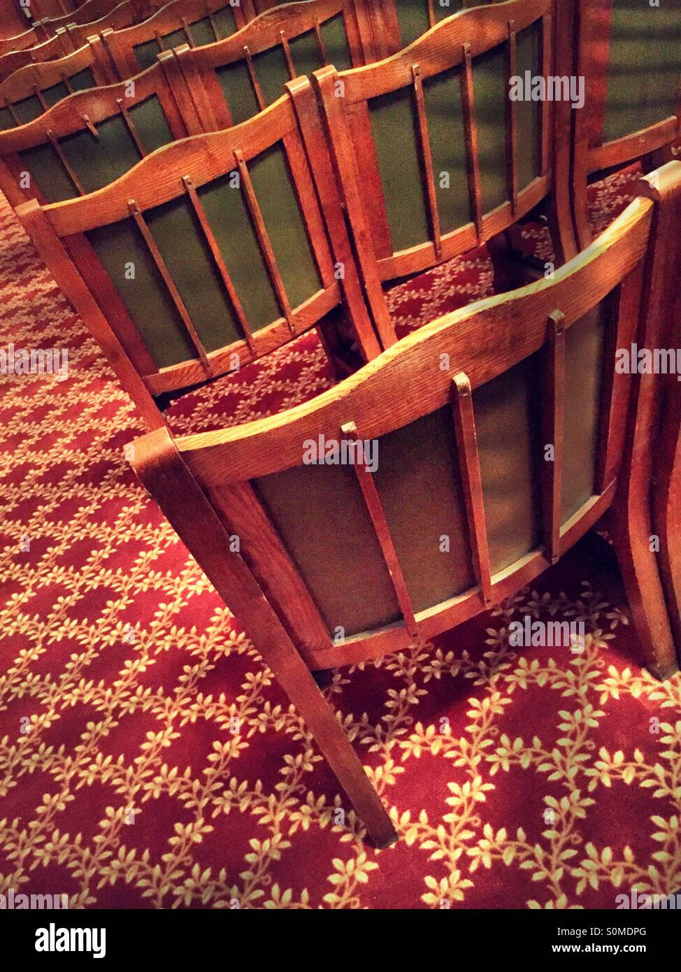 Vintage wooden chairs aligned for a program audience Stock Photo - Alamy