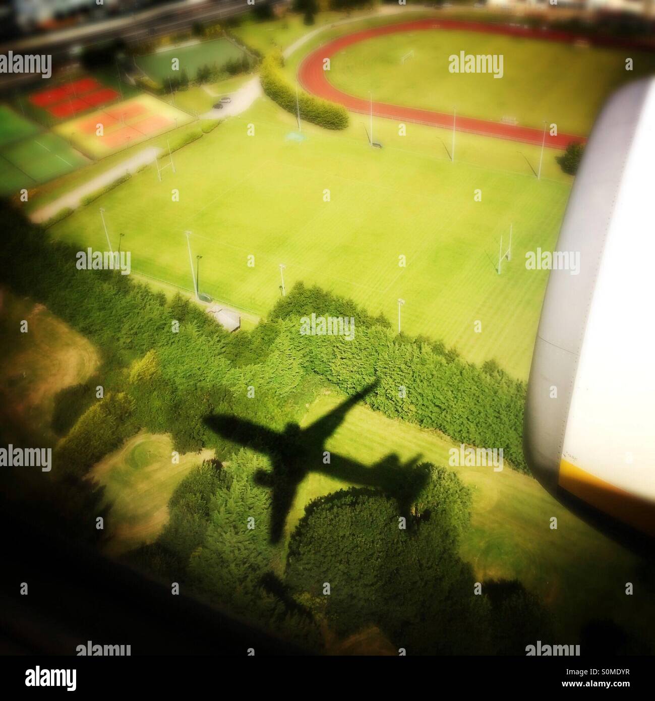 Shadow of airplane on the ground as seen from airplane window moments ...
