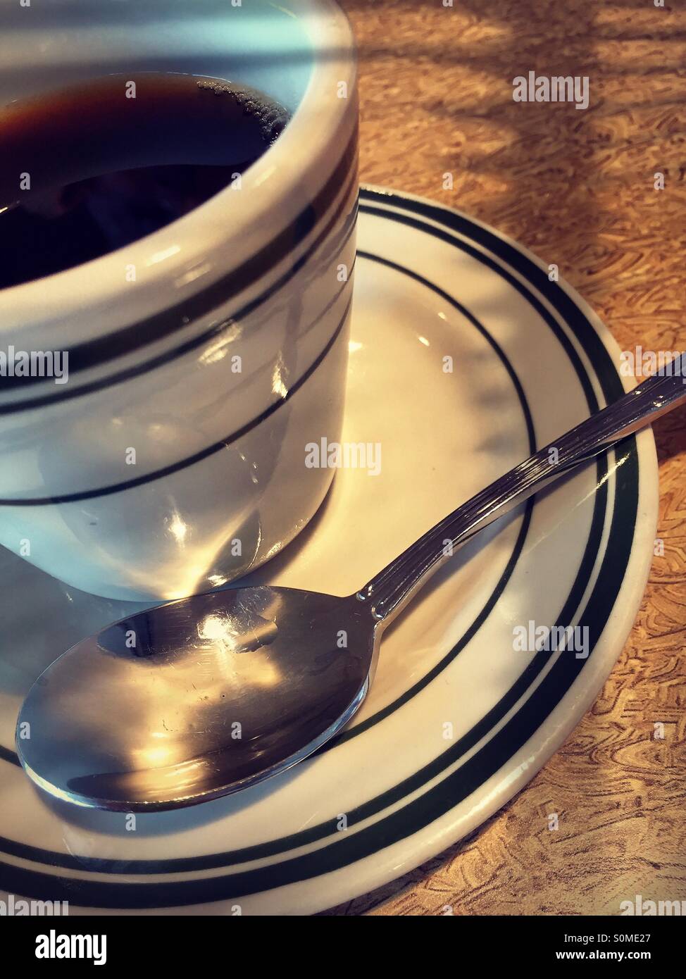 Coffee Cup saucer and spoon on diner counter Stock Photo - Alamy