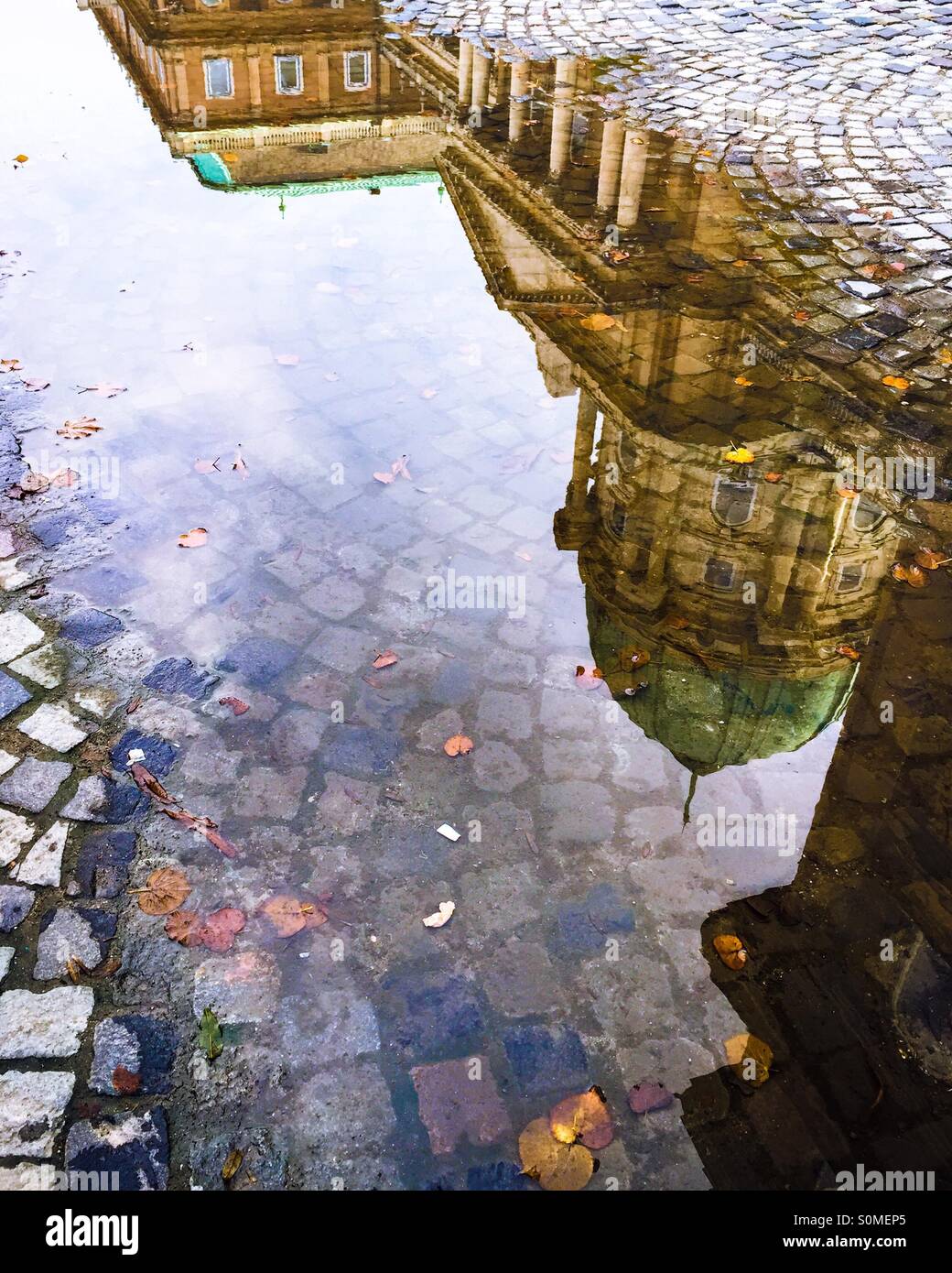 Autumn in Budapest. Buda castle reflecting in a rain puddle on ...